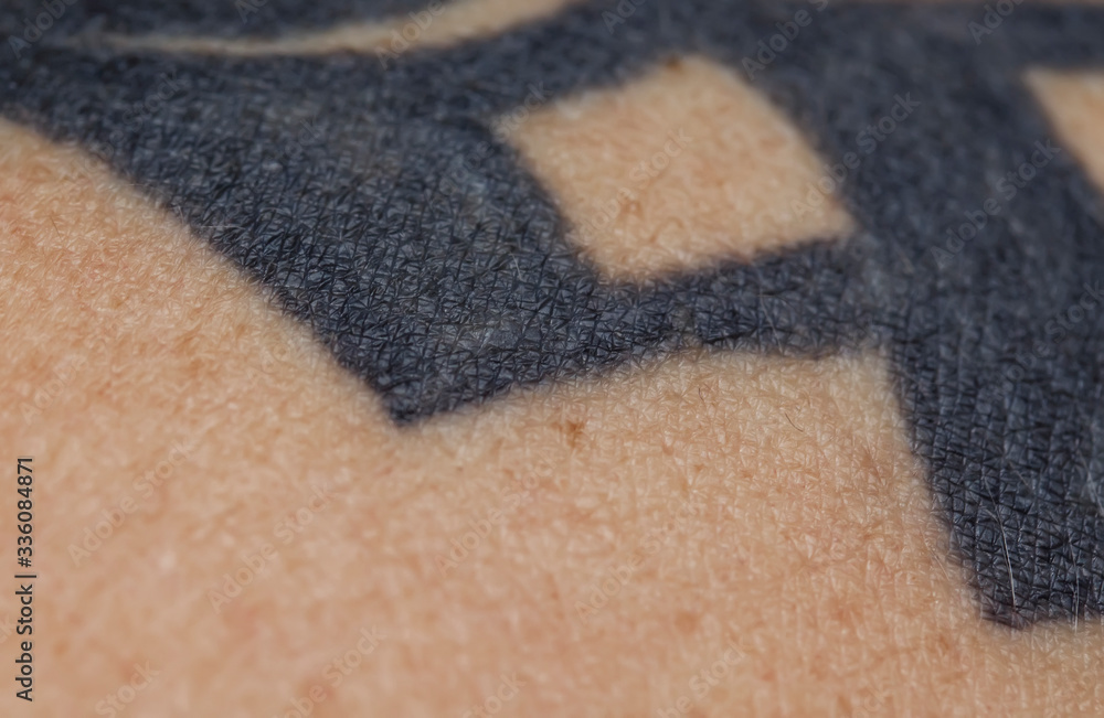 texture of the back of a person's skin close-up with stuffed black ...