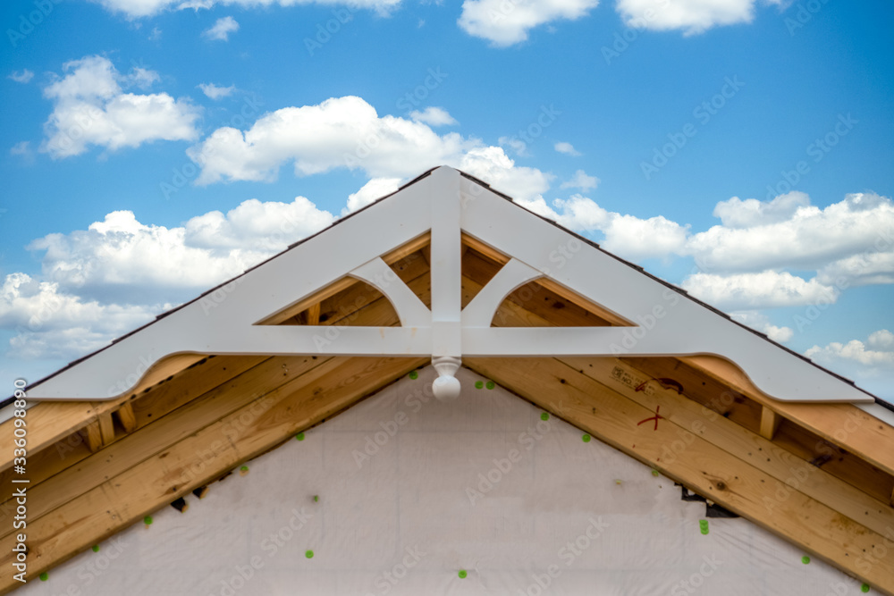 In focus colonial white decorative gable beam bracket on a house under ...