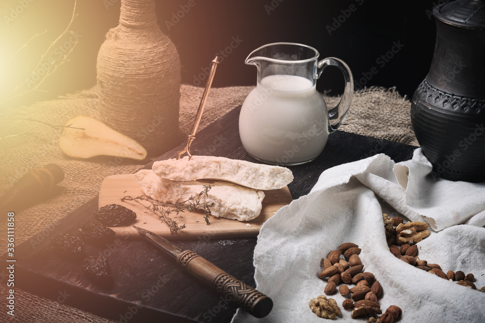 Still life in a dark key on a medieval theme. cheese made according to ...