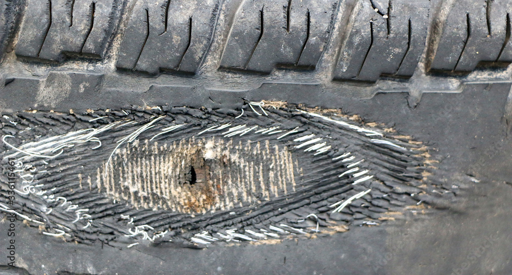 rubbed wheel of lorry. worn wheel with hole in tire, worn rubber tread ...