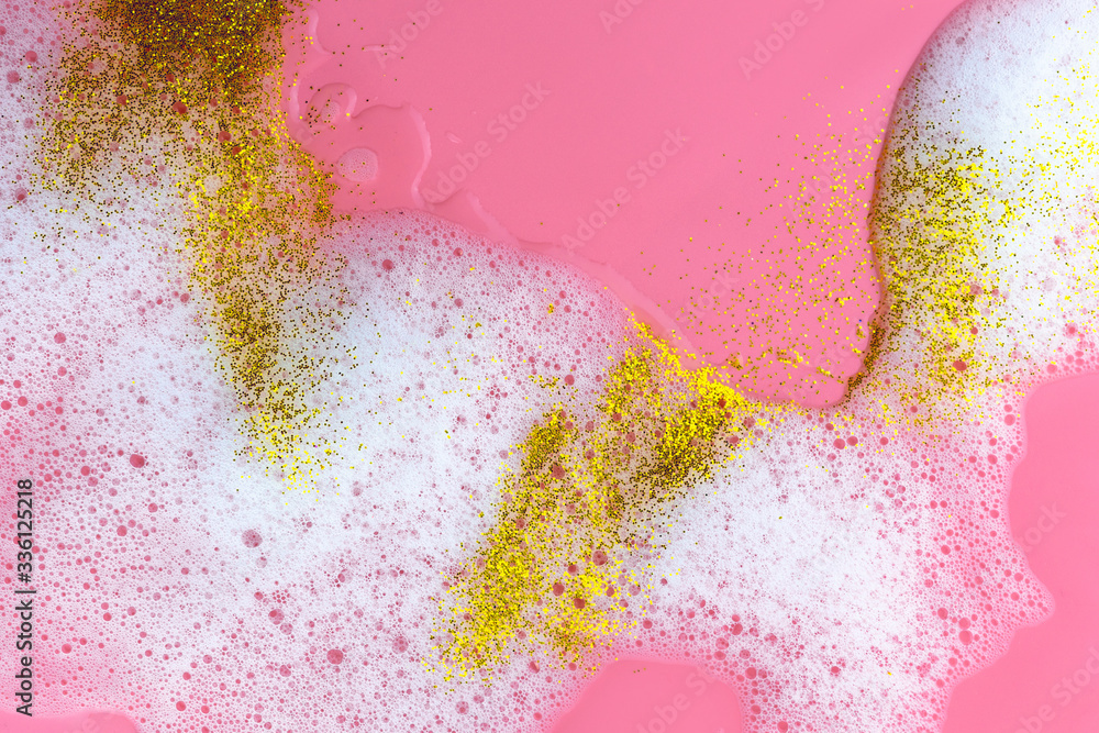 Pink background with soap foam and gold sparkles. Copy space. Pink ...