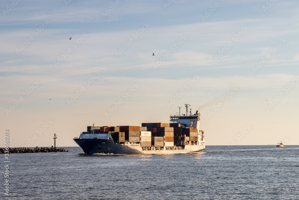 Evening scenery of harbor when sun sets. Lithuanian freighter. Vessel ...