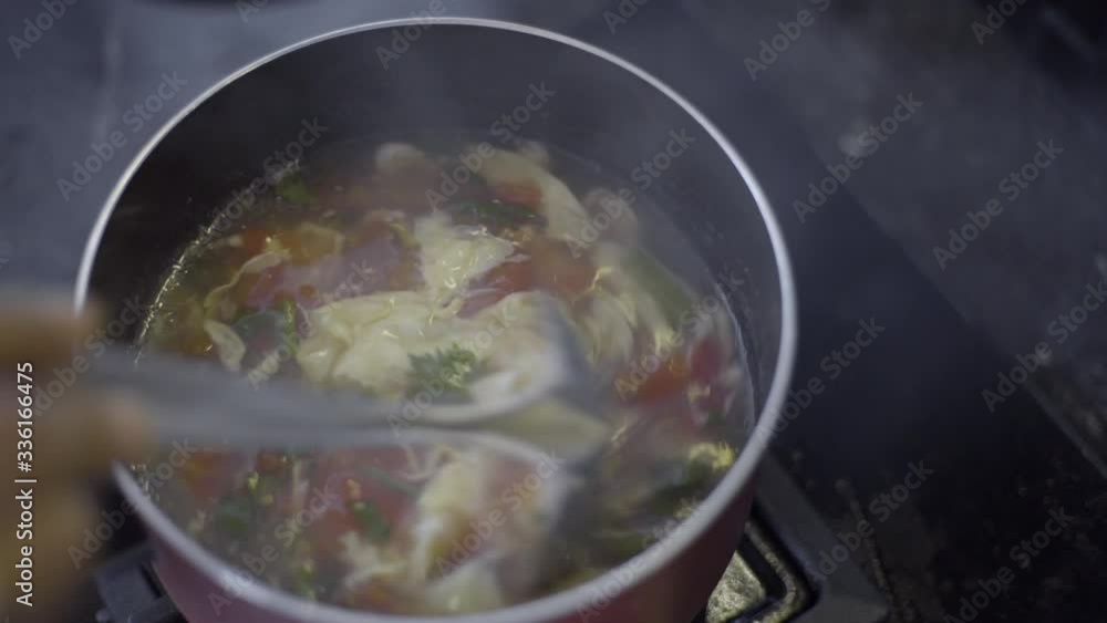 Close up water boiling on pan. Man boiling the water with chopped ...