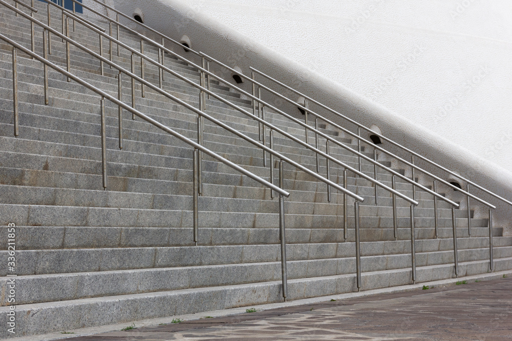 Empty staircase with aluminum railings across. Nobody on building ...