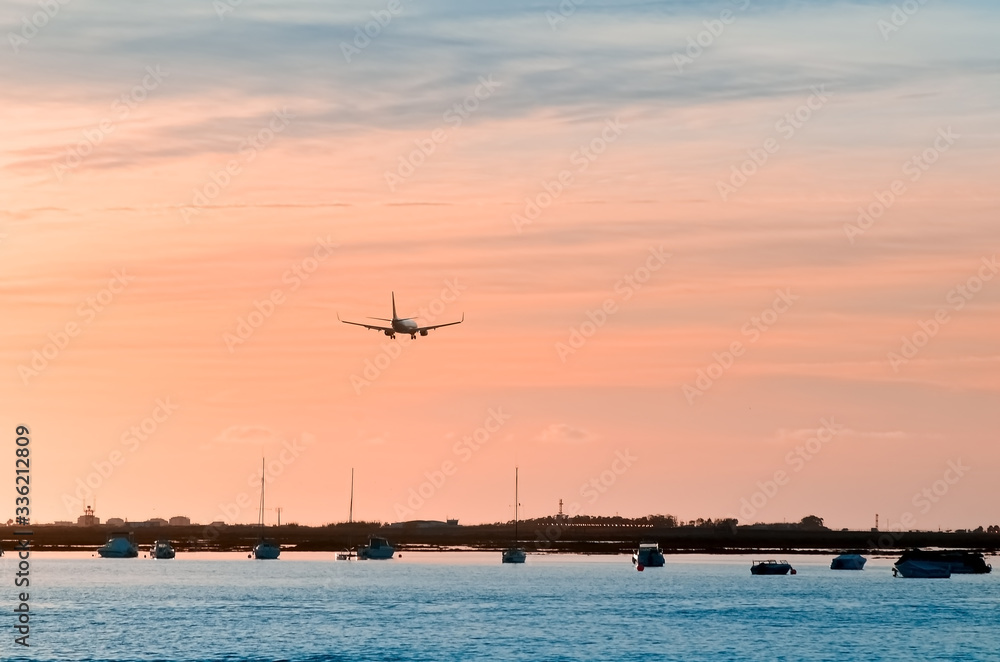 The plane flies to the airport over the river in the city of Faro in ...