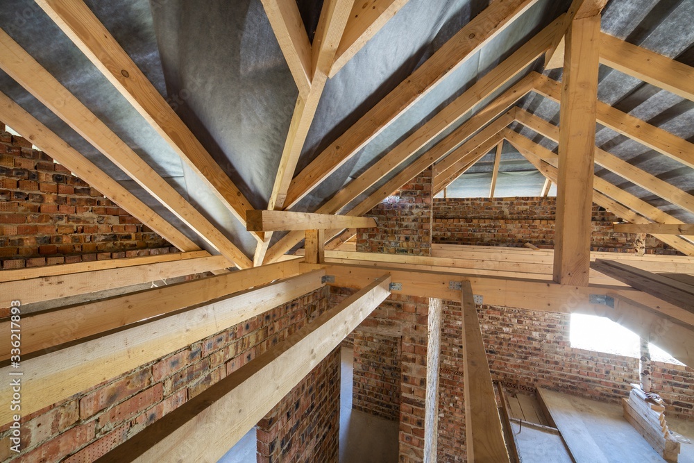 Attic of a building under construction with wooden beams of a roof ...