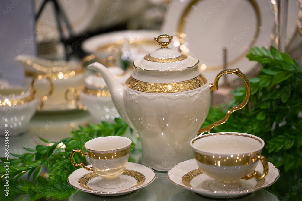 Arrangement of a luxury porcelain dinnerware with golden hand painted ...