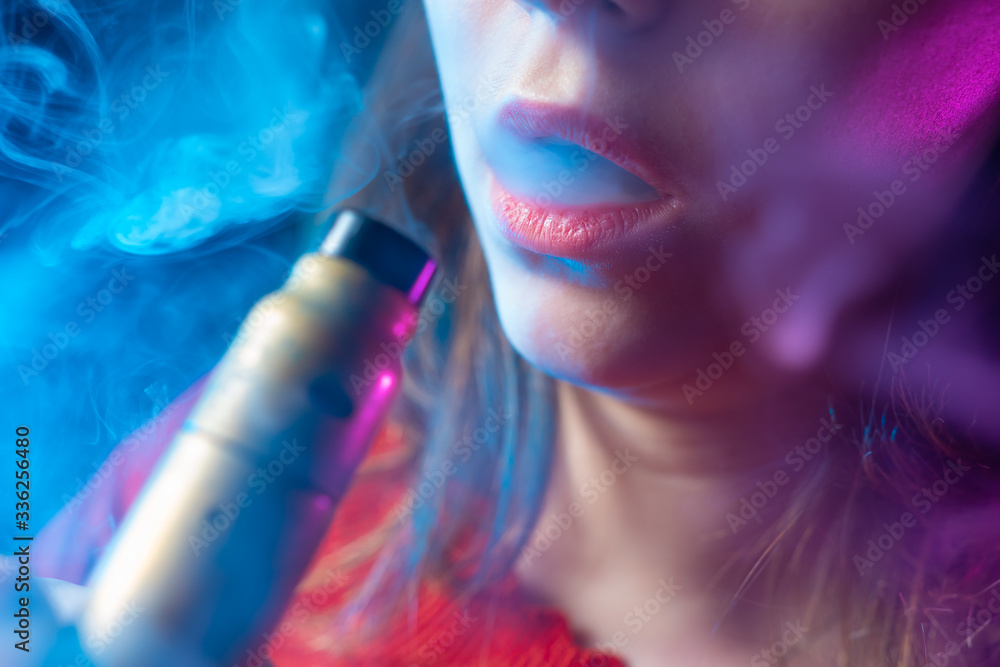 The vaper girl. Vaper girl lips close up. Woman with an electronic ...