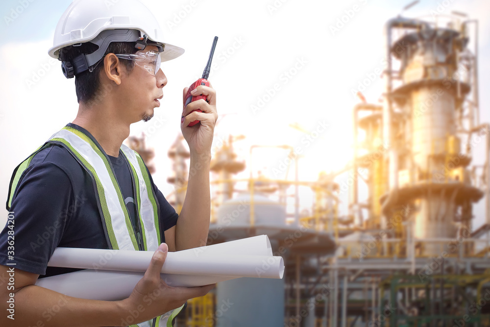 Engineering personnel in standard safety uniform work in gas turbine ...