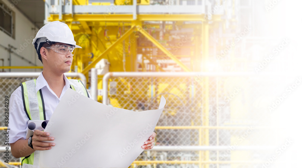 Engineering personnel in standard safety uniform work in gas turbine ...