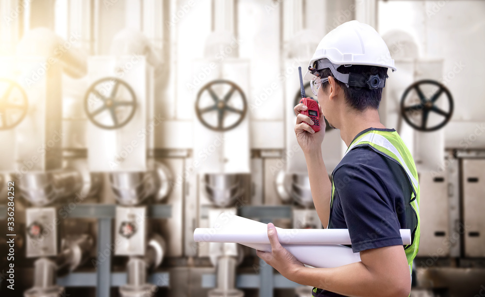 Engineering personnel in standard safety uniform work in gas turbine ...