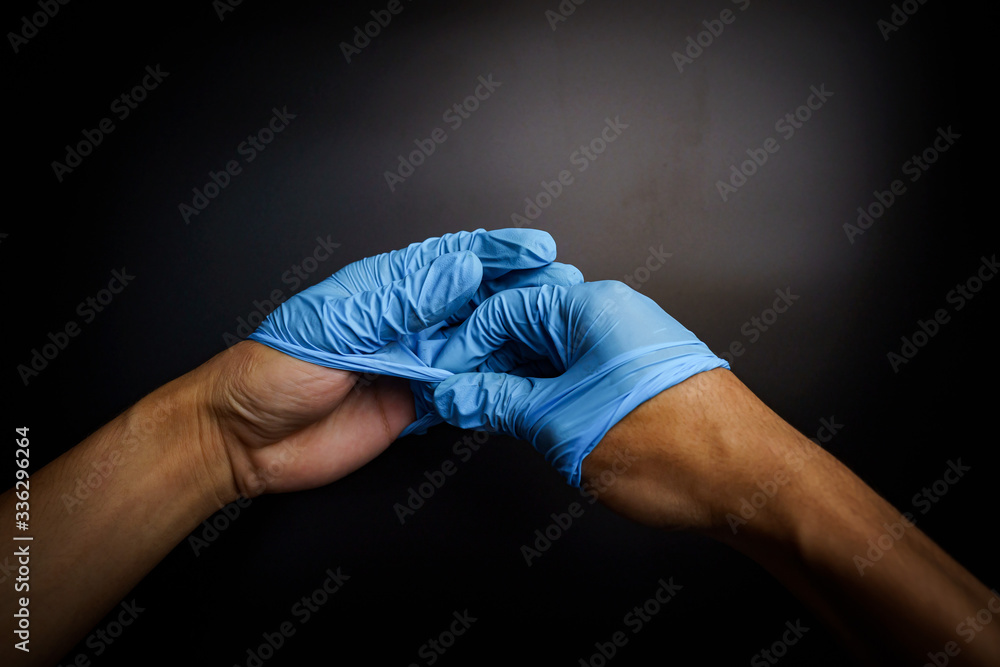 Human hands in blue surgical gloves by gesture take off hands isolated ...