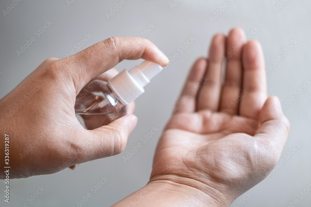 Women washing hands with alcohol spray clean hands hygiene prevention ...