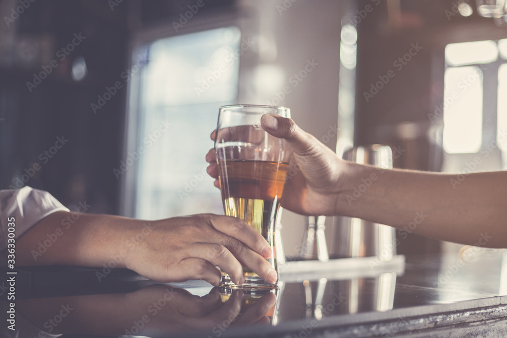 bartender serving beer for customer in counter at nightclub Stock Photo ...