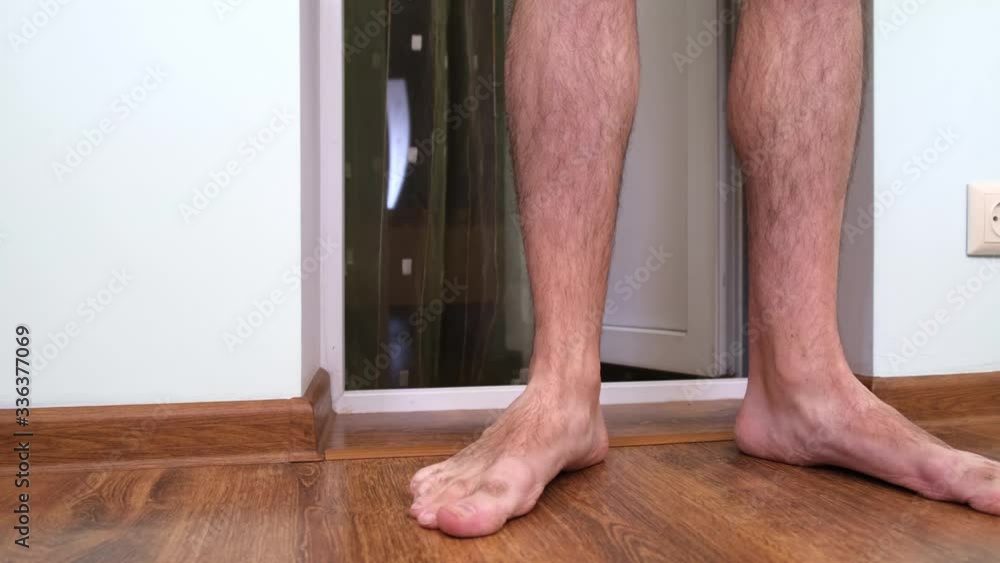 Frumpy Man With Hairy Legs In Shorts Barefoot Crosses The Threshold