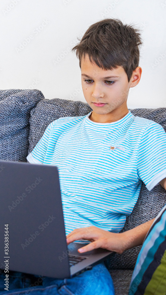 Preteen boy using laptop computer at home. Technology, online learning ...