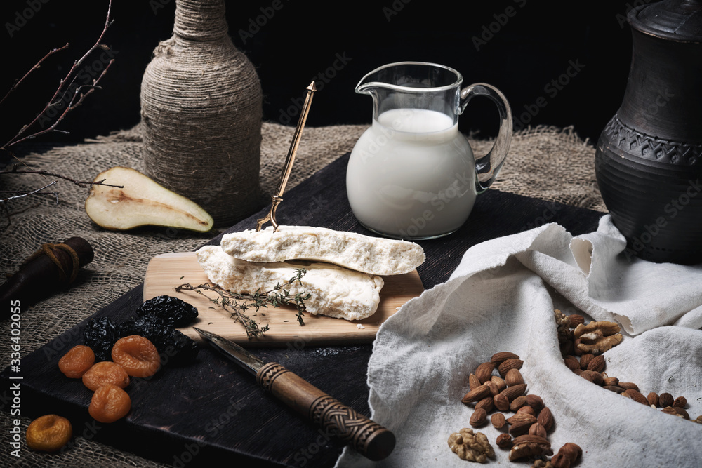 Still life in a dark key on a medieval theme. cheese made according to ...