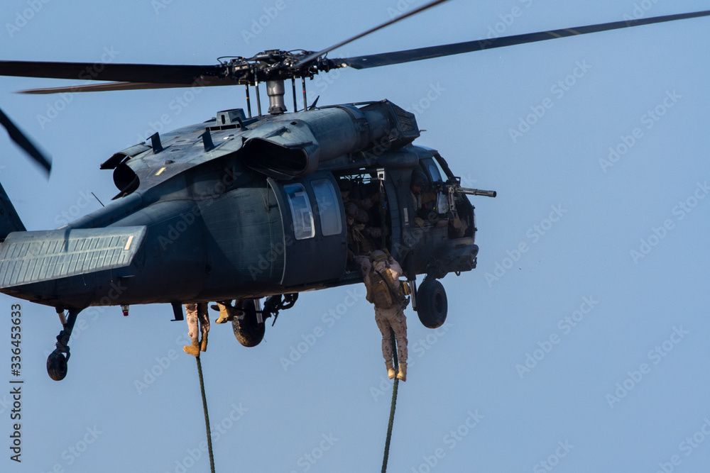 Military combat and war with helicopter flying into the chaos and ...