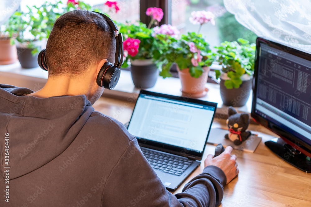 Working from home during COVID 19 lockdown. Man in front of a laptop ...