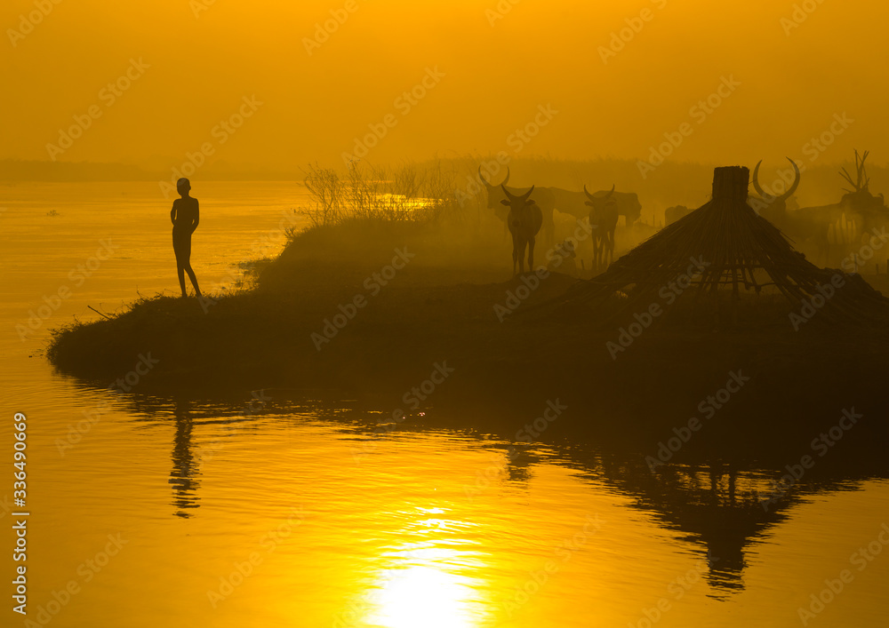 Mundari tribe child on the bank of river Nile at sunset, Central ...
