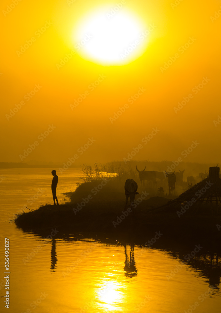 Mundari tribe child on the bank of river Nile at sunset, Central ...