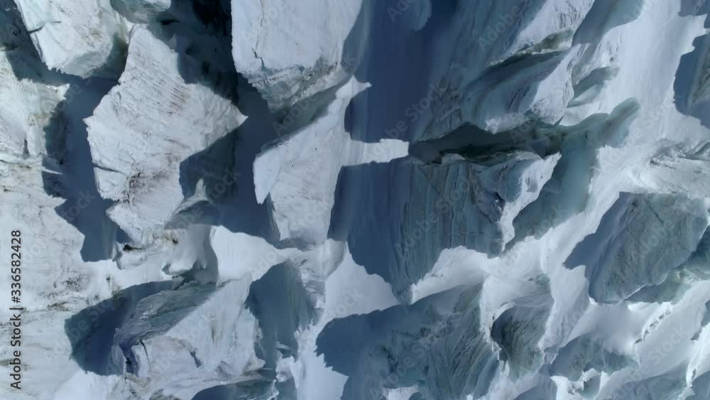 Flight above glacier icy ice mass frozen sharp beautiful peaks ...