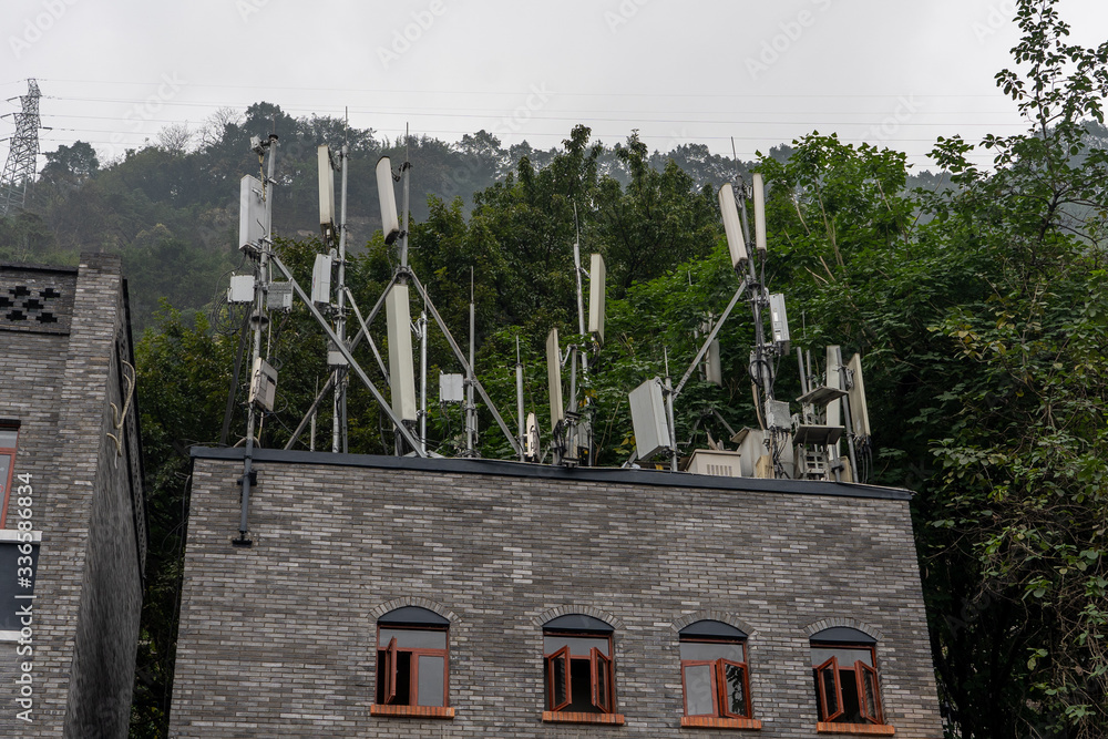 5G antenna base station on top of residence building in the mountain in ...