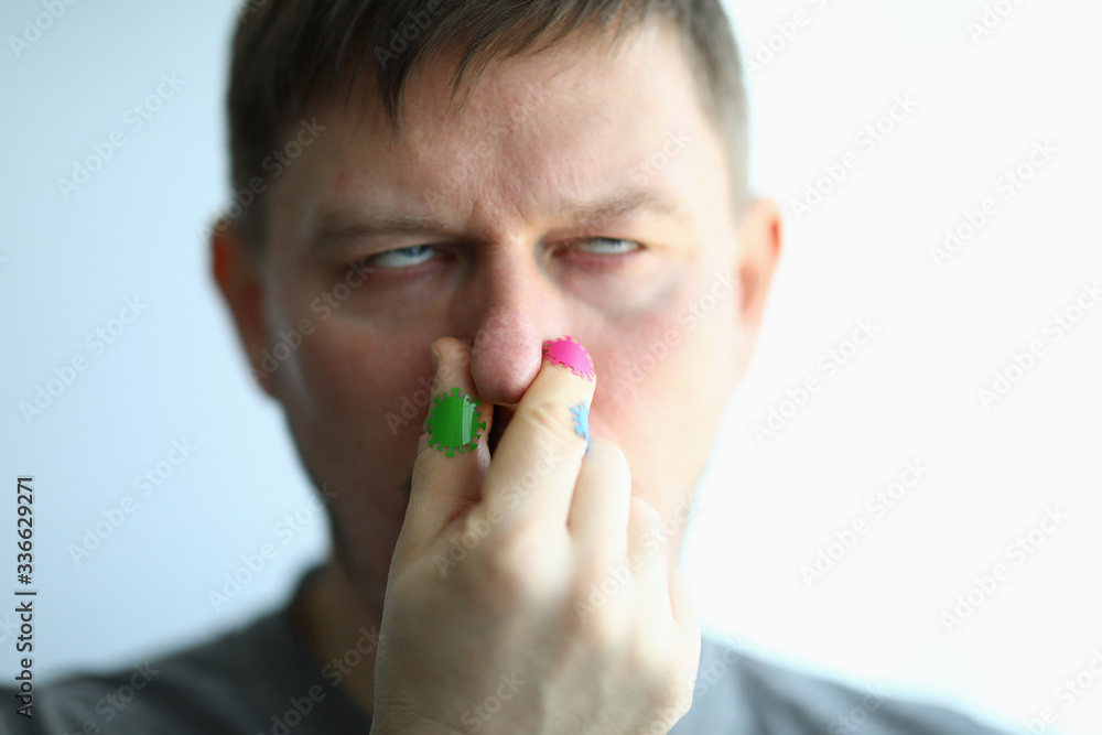 Close-up of middle-aged man scratching nose with dirty hand. Invisible ...