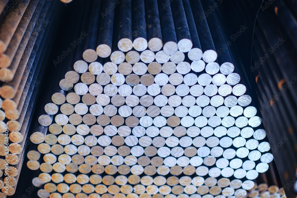 Round steel section rolling profile in stacked. Warehouse of metal ...