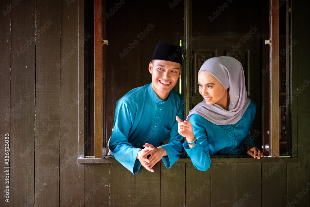 A portrait of young couple of malay muslim in traditional costume ...