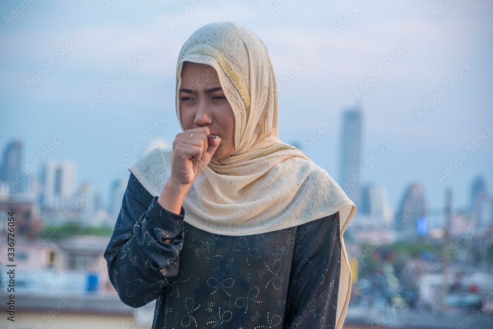 Islamic woman wearing hijab and coughing because the air is dusty, the ...