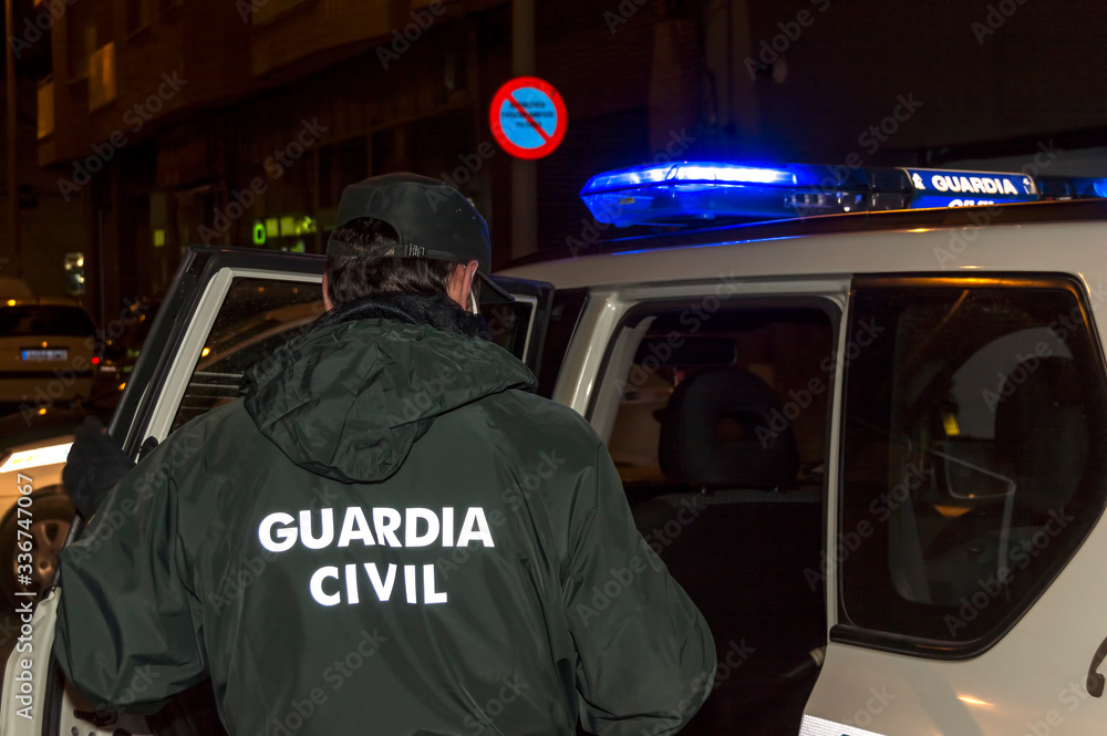 Guardia Civil enters the patrol car at a checkpoint during the Covid-19 ...