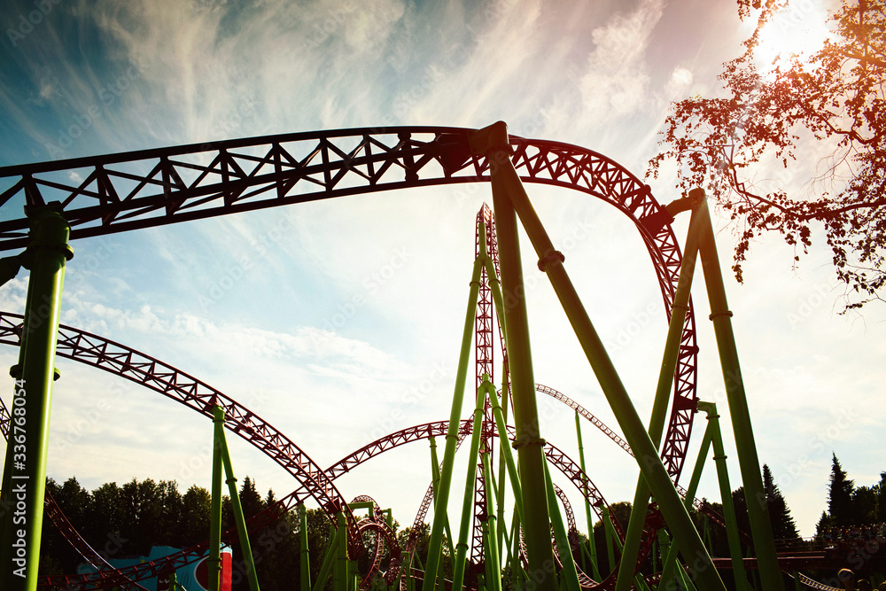 Roller coaster silhouette at sunset in an amusement park. Summer ...