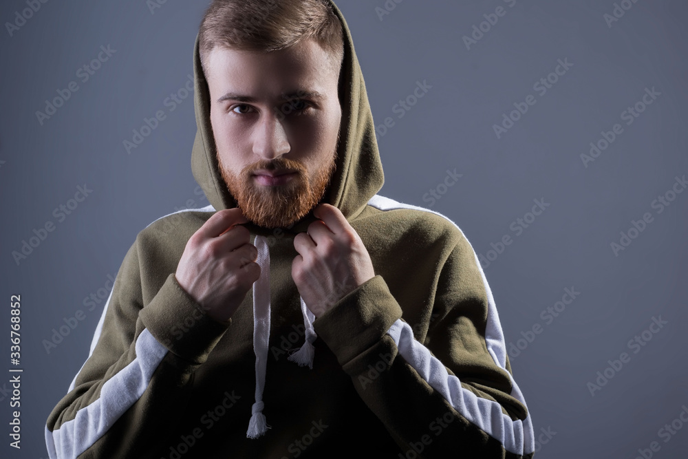 Studio portrait of a young bearded guy of twenty-five years old. in a ...