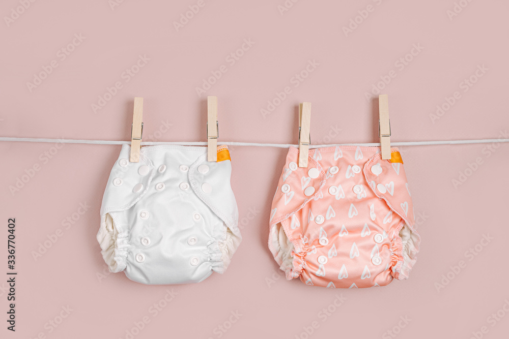 Reusable cloth baby diapers drying on a clothes line. Eco friendly ...