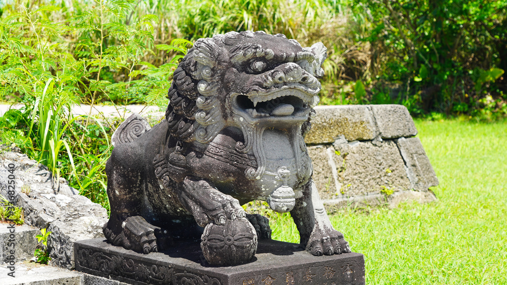 ancient japanese sculptures of mythical shisa on a green background ...