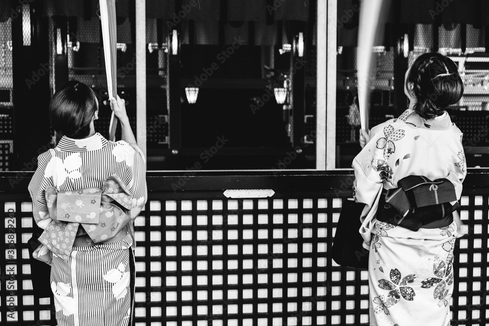 Women with kimono ringing the bell at hondo in Fushimi Inari taisha ...