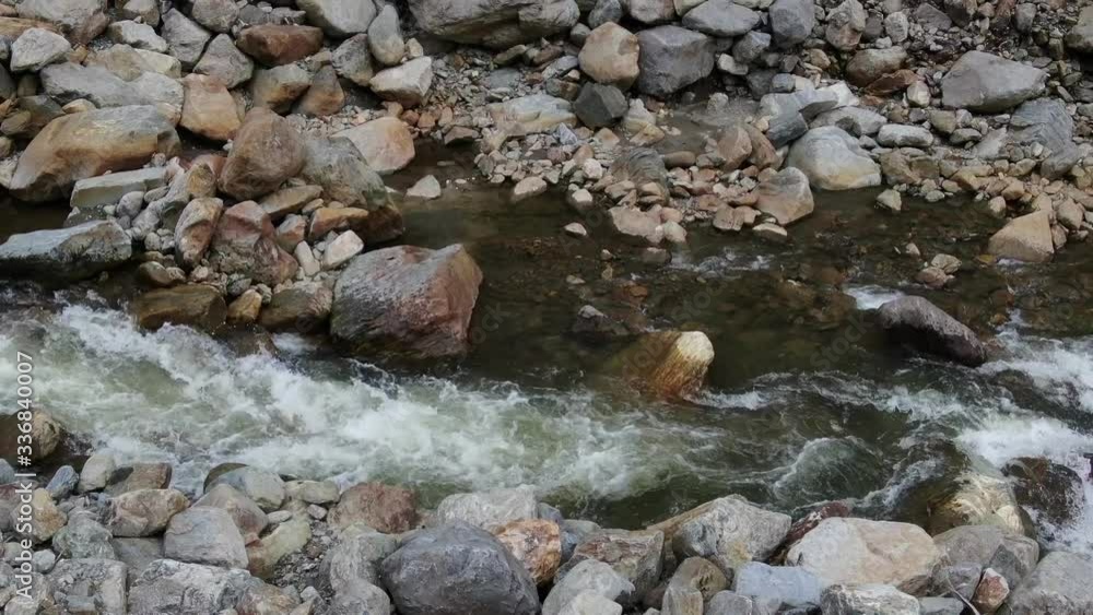 Clean clear water flows from river through rock Stock Video | Adobe Stock