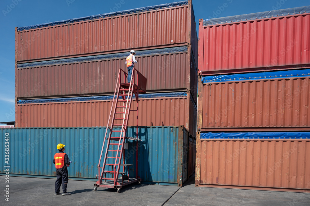 Foreman control loading containers box from cargo freight ship for ...