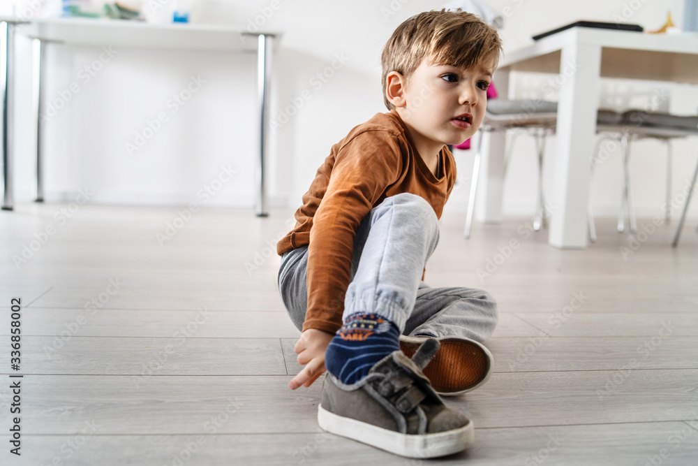 Full length view of small cute caucasian boy little child kid sitting ...