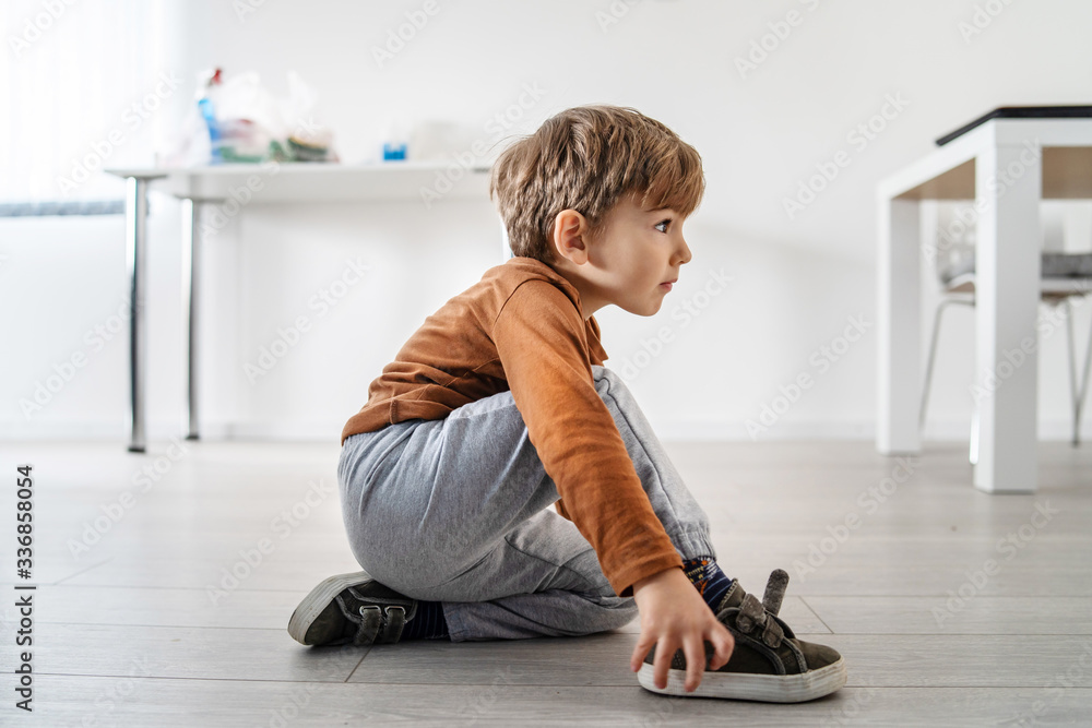 Full length view of small cute caucasian boy little child kid sitting ...