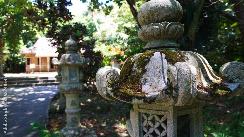 ancient Japanese statues, lanterns on the road through the jungle to a ...