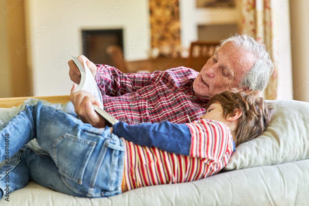 Grandpa reading a book with his grandson Stock Photo | Adobe Stock