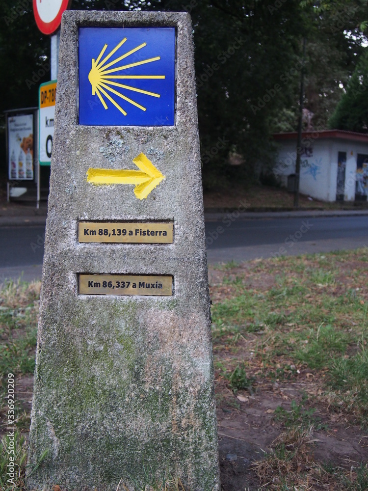 Yellow scallop shell mark and arrow sign, Camino de Santiago, Way of St ...