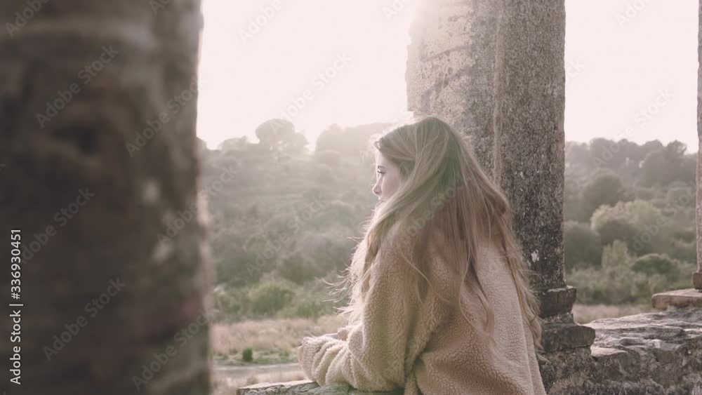 Dolly out slow motion video of a young female model looking in wonder ...