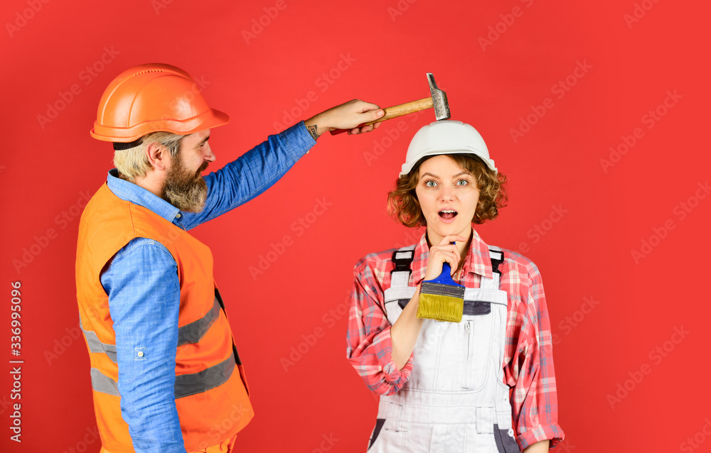 Foto de Intelligibly concept. Couple renovating apartment together. Man ...