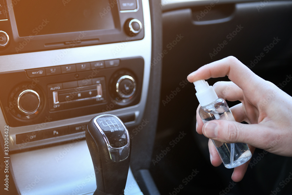 Cleansing car interior and spraying with disinfection liquid ...