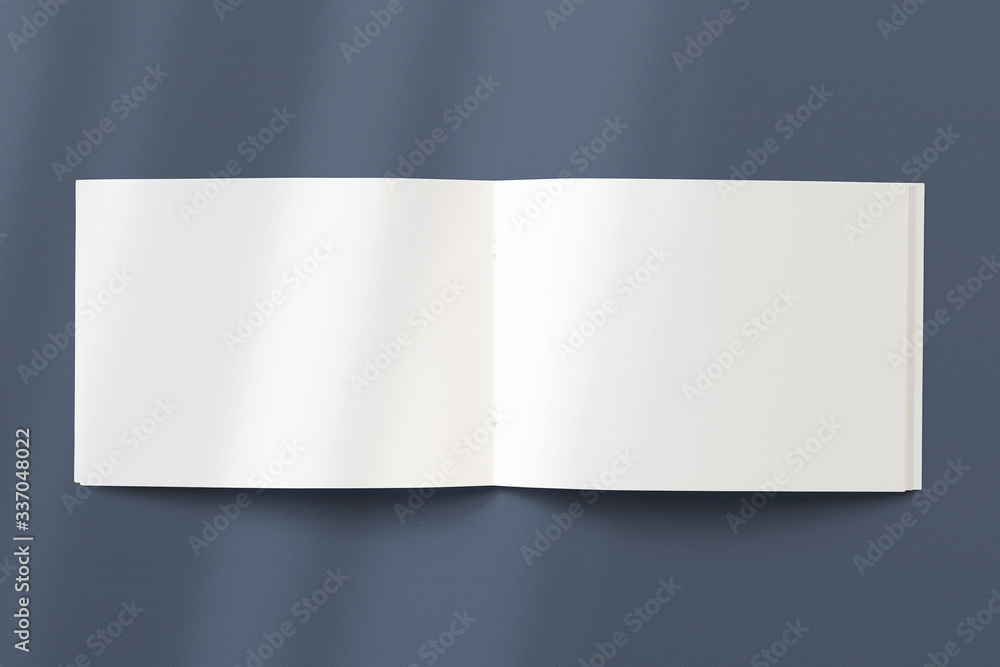 Top view opened landscape magazine pages with shadow overlay from above ...