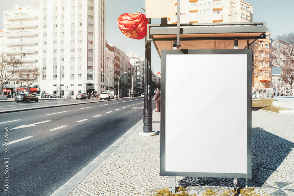 Blank advertising billboard mockup outside the bus stop; an empty ...