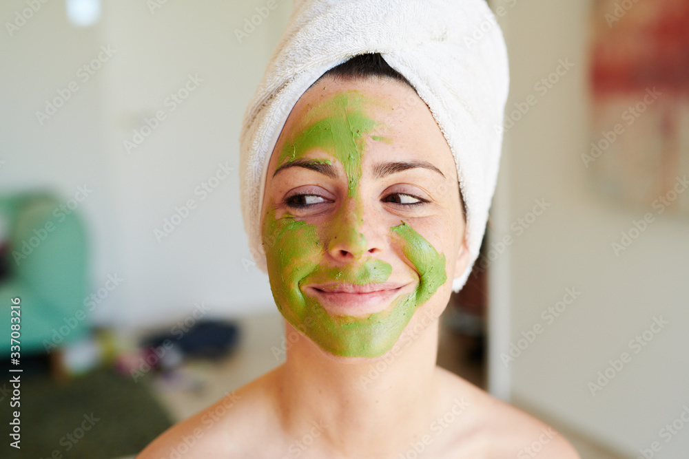 Beautiful woman with green face mask. Stock Photo | Adobe Stock